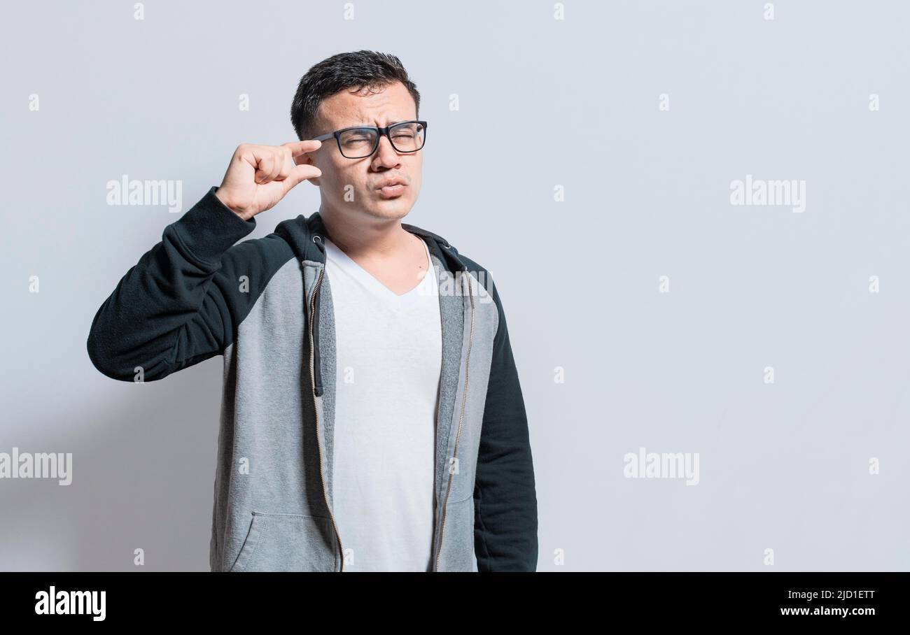 People gesturing with his hand showing something small size with his ...