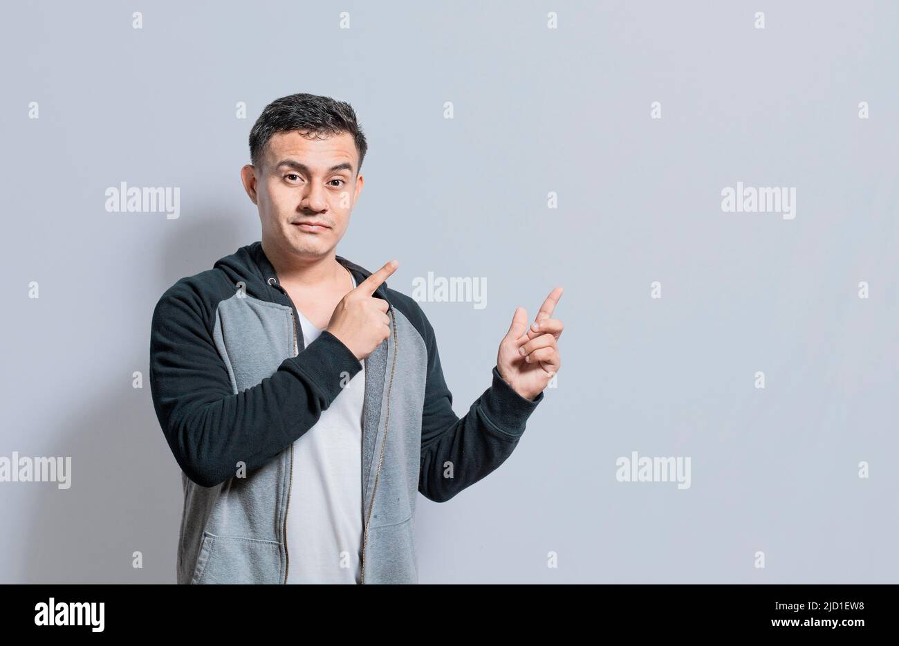 Smiling handsome man recommending something with fingers isolated ...