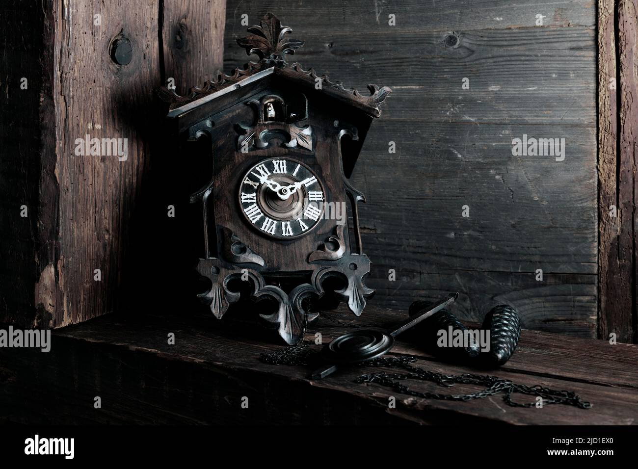 Antique Black Forest cuckoo clock on wooden background, studio shot ...