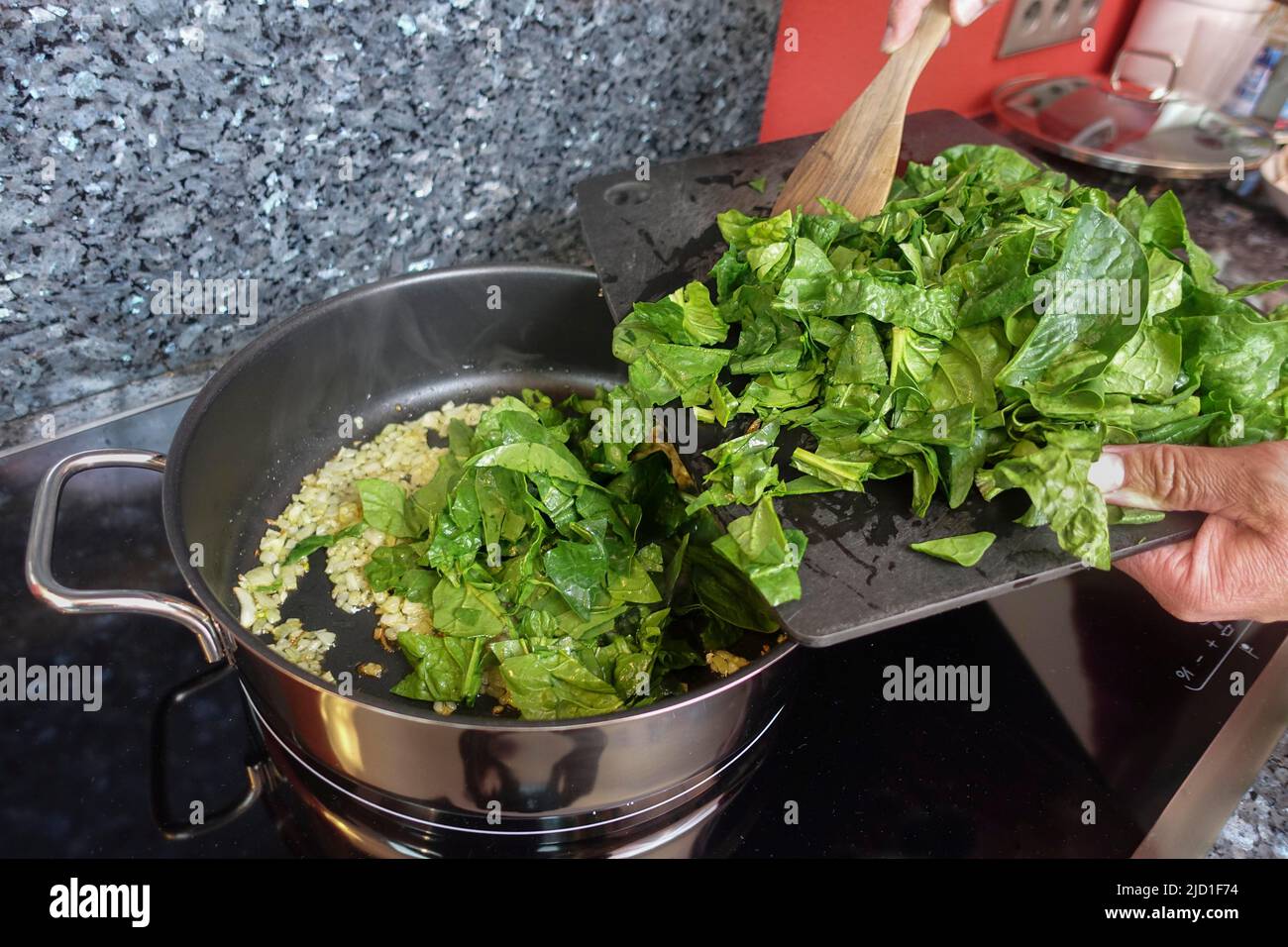 Swabian cuisine, preparing spinach cake with shortcrust pastry base ...