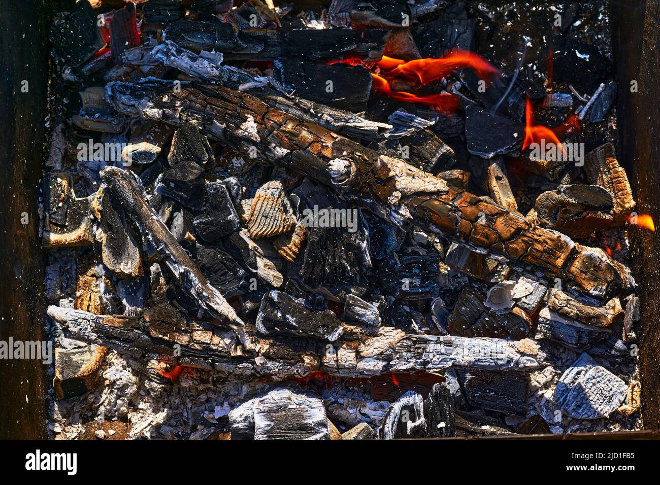 Campfire with fading flame and smoldering coals. Time for cooking meat ...