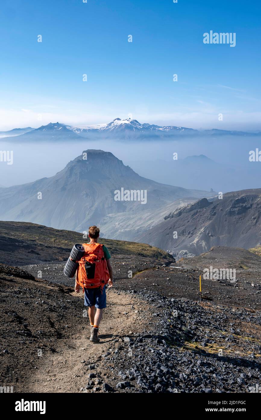 Hikers on hiking trail through volcanic landscape, view of mountains ...
