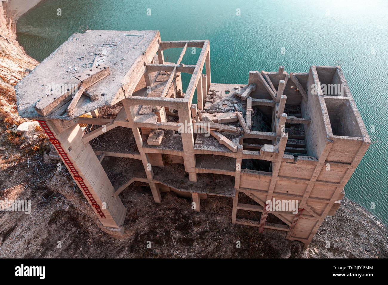 aerial view of an abandoned concrete building near a dam Stock Photo ...