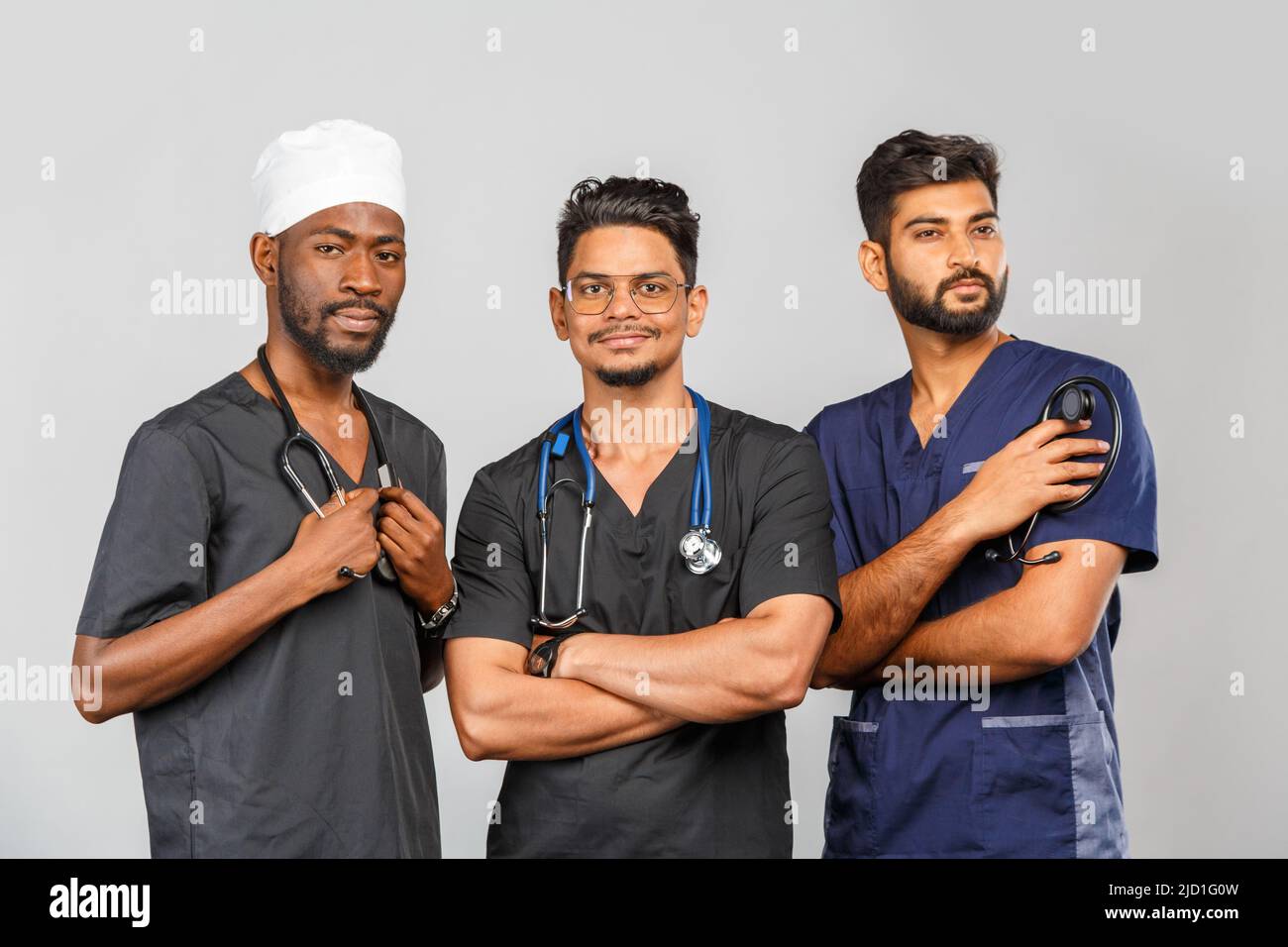 attractive medical team standing together over light gray background ...