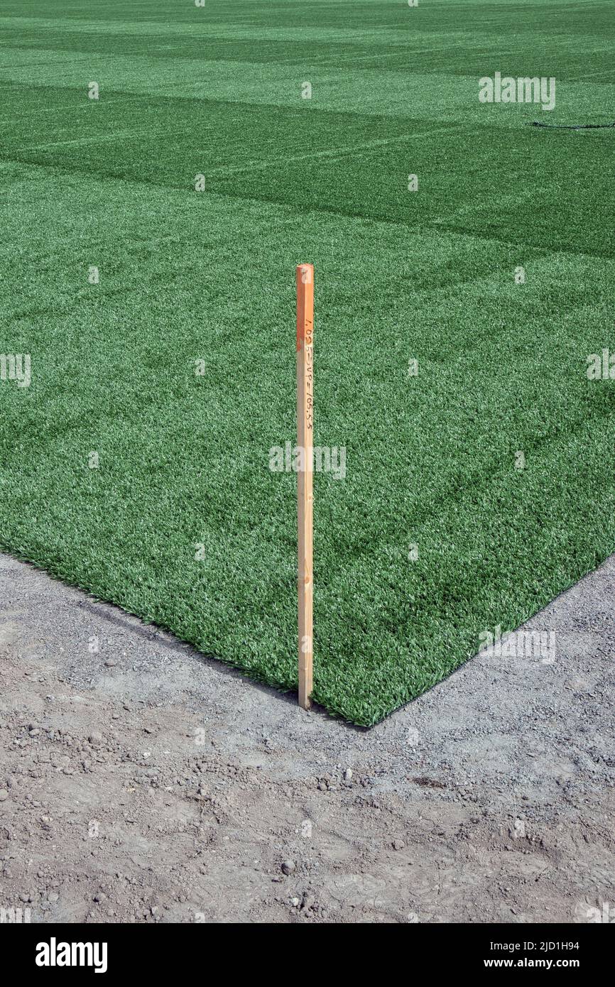 Artificial grass laying at a outdoor sports field Stock Photo - Alamy