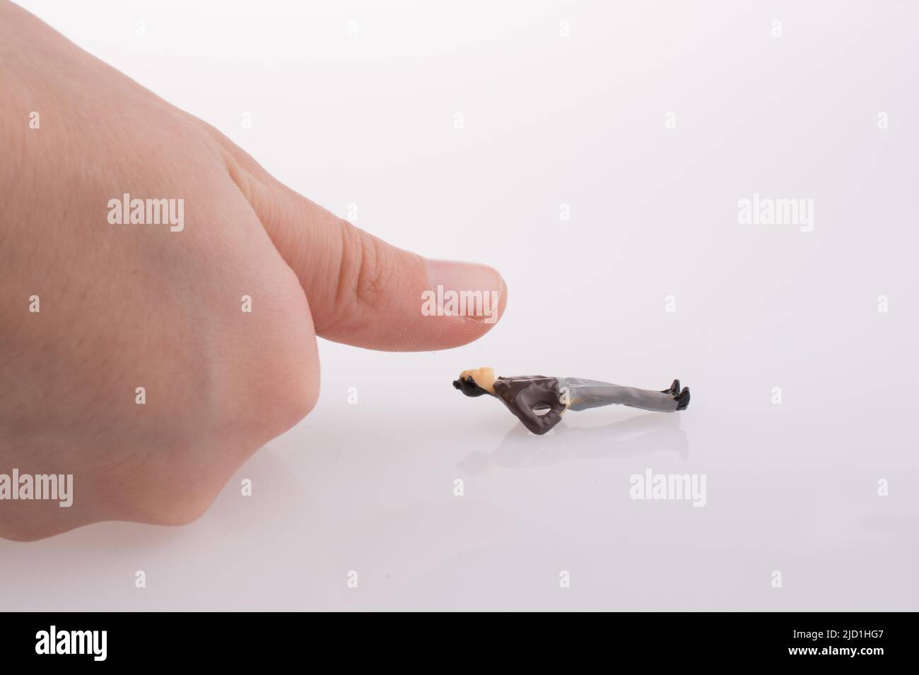 Hand threatening to smash human figure on a white background Stock ...