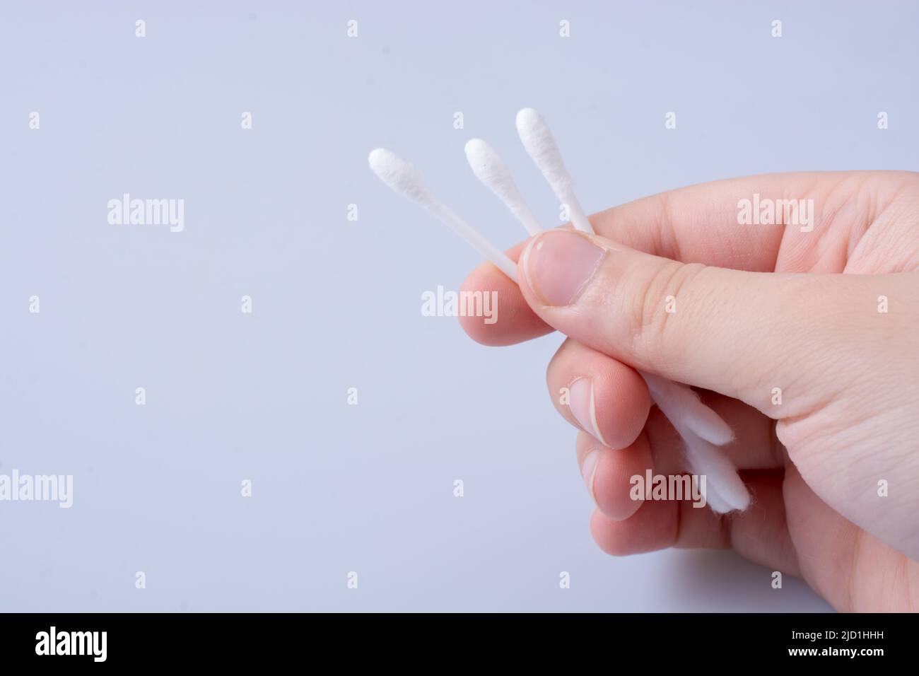 A few ear sticks in hand isolated on white background Stock Photo - Alamy