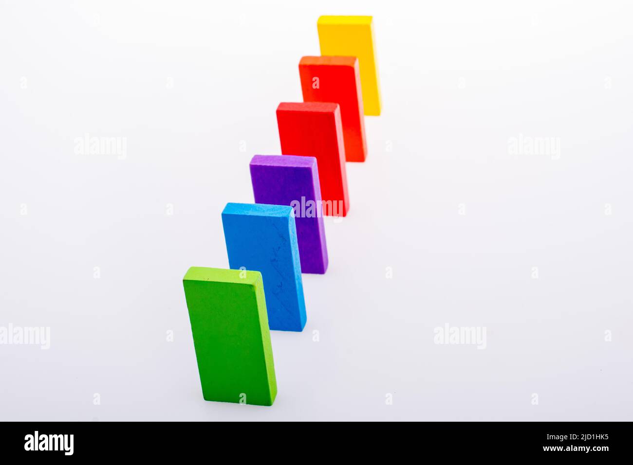 Colorful Domino Blocks in a line on a white background Stock Photo - Alamy