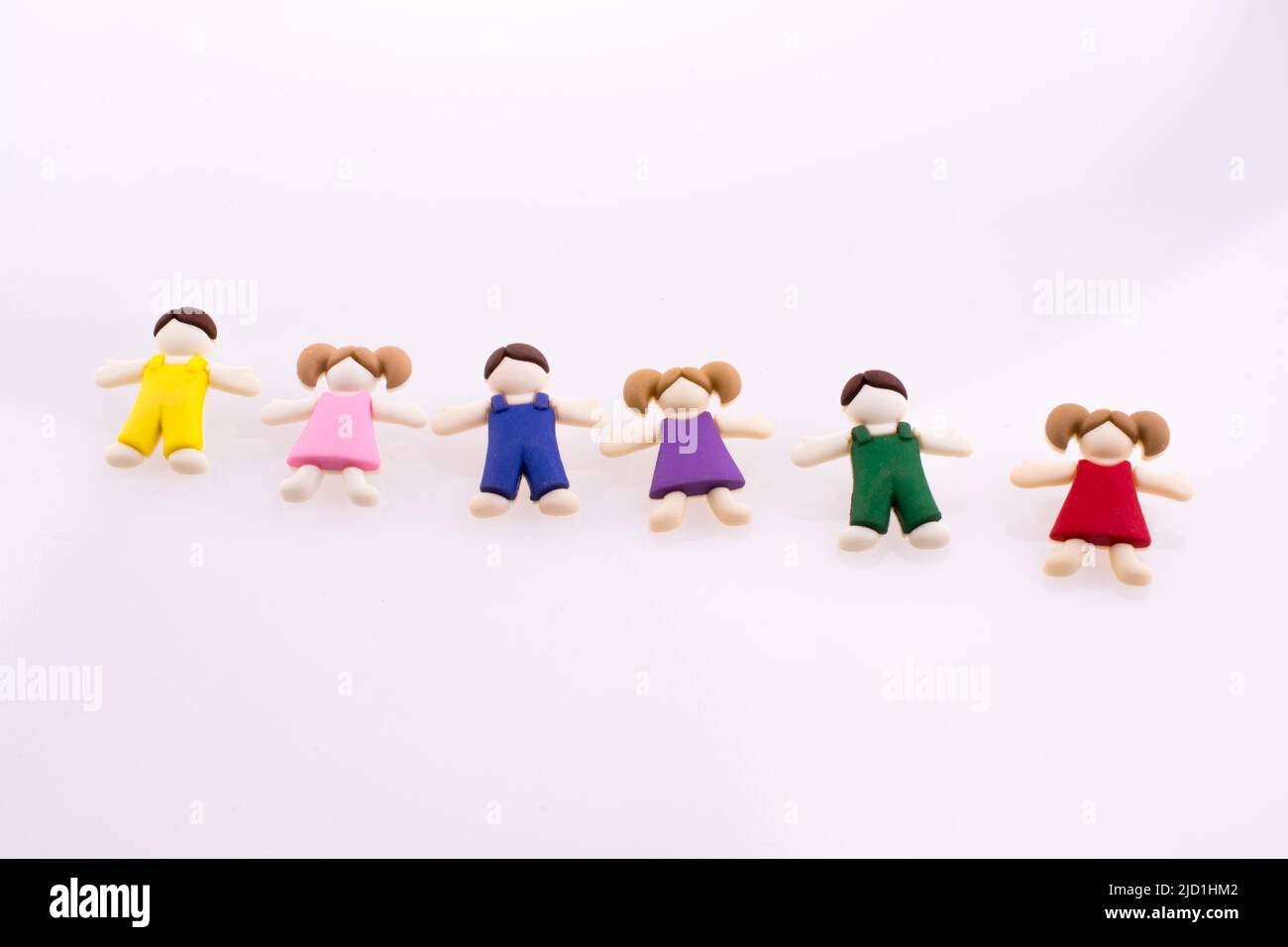 Colorful dressed children figures on a white background Stock Photo - Alamy