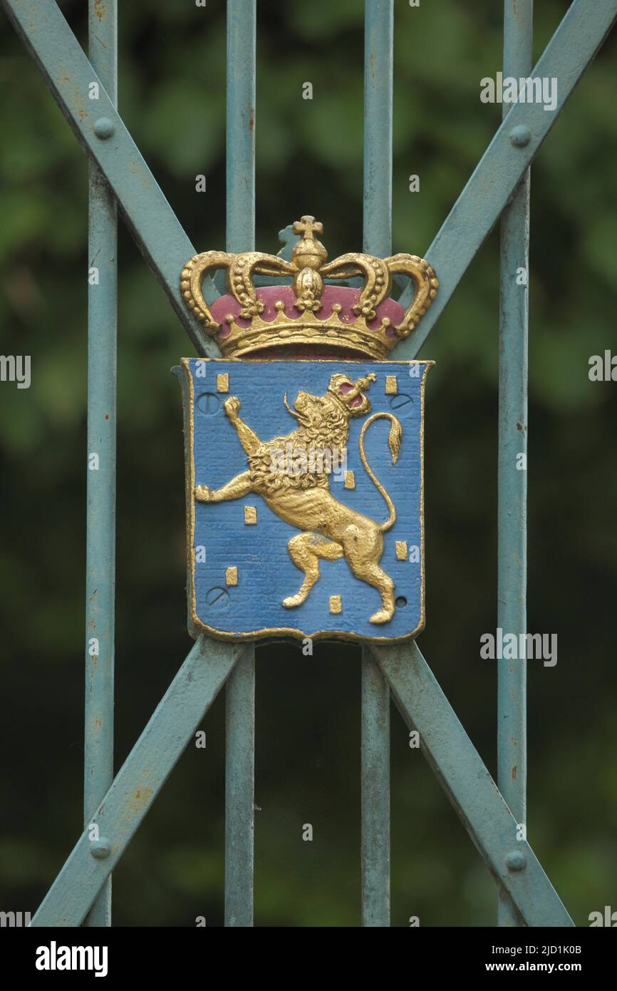 Coat of arms with golden lion figure and crown at the gate to the ...