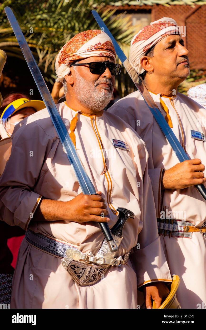 Men performing traditional songs during the Friday Goat Market in Nizwa ...
