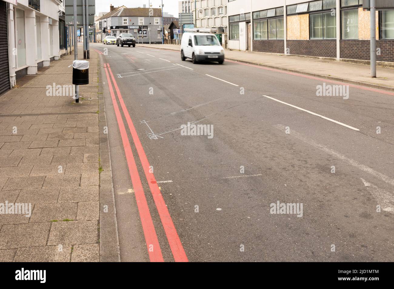 Double red line near curb on asphalt road. These indicate stopping ...