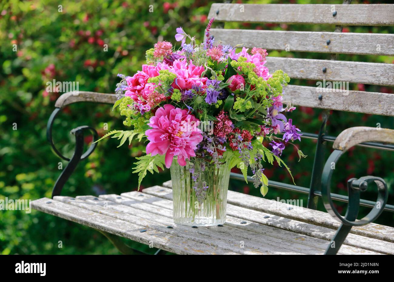 Colourful bouquet in red, pink and purple shades with peonies and ...