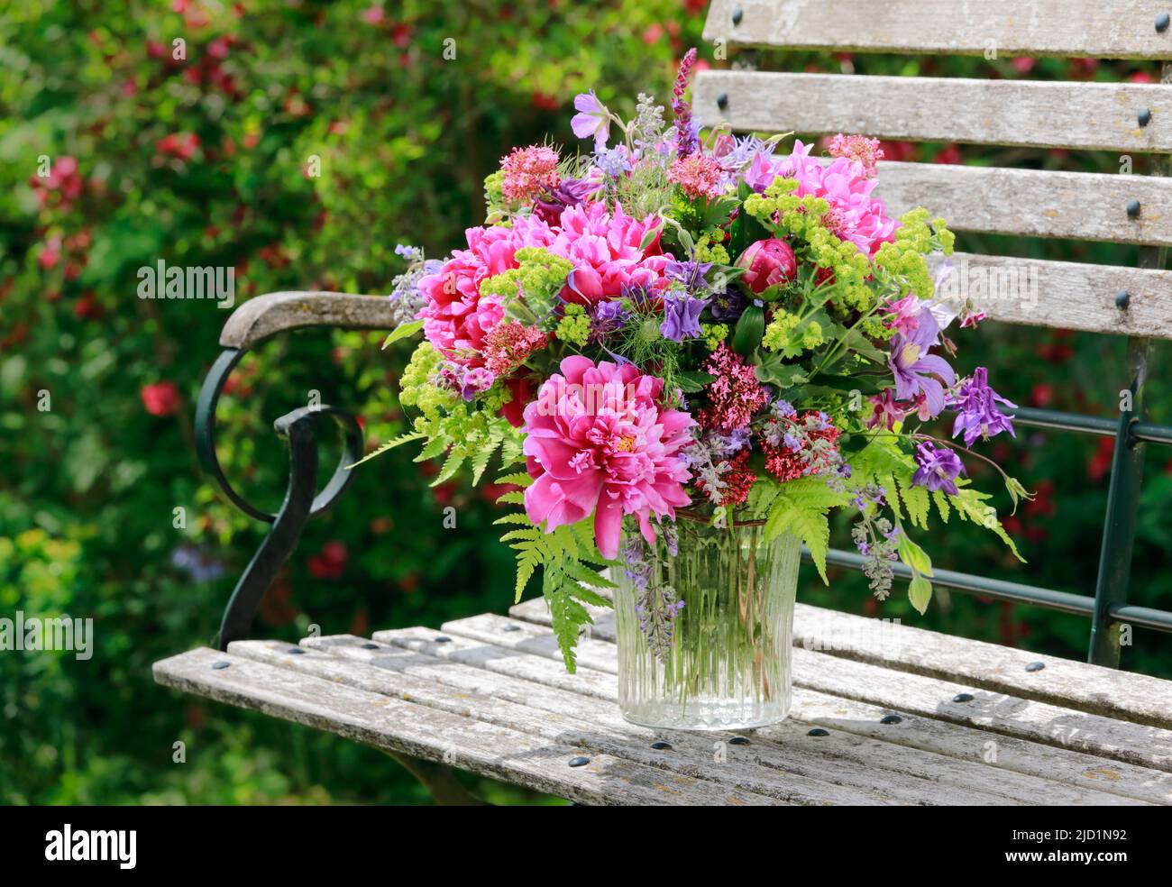 Colourful bouquet in red, pink and violet shades with peonies and ...