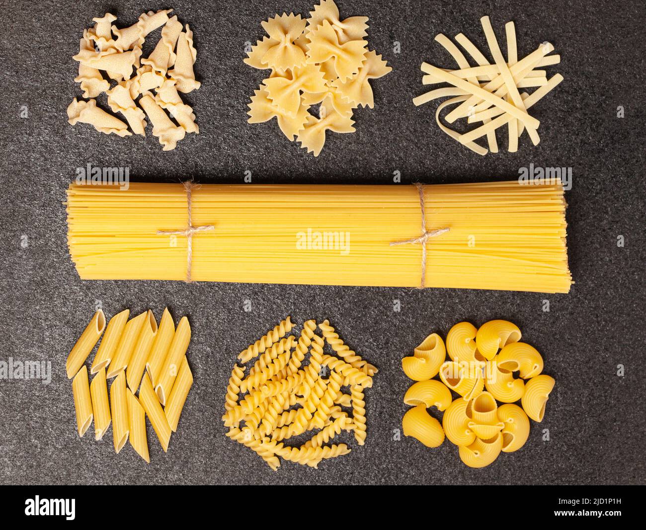 Spaghetti with variety of types and shapes of Italian pasta on black ...