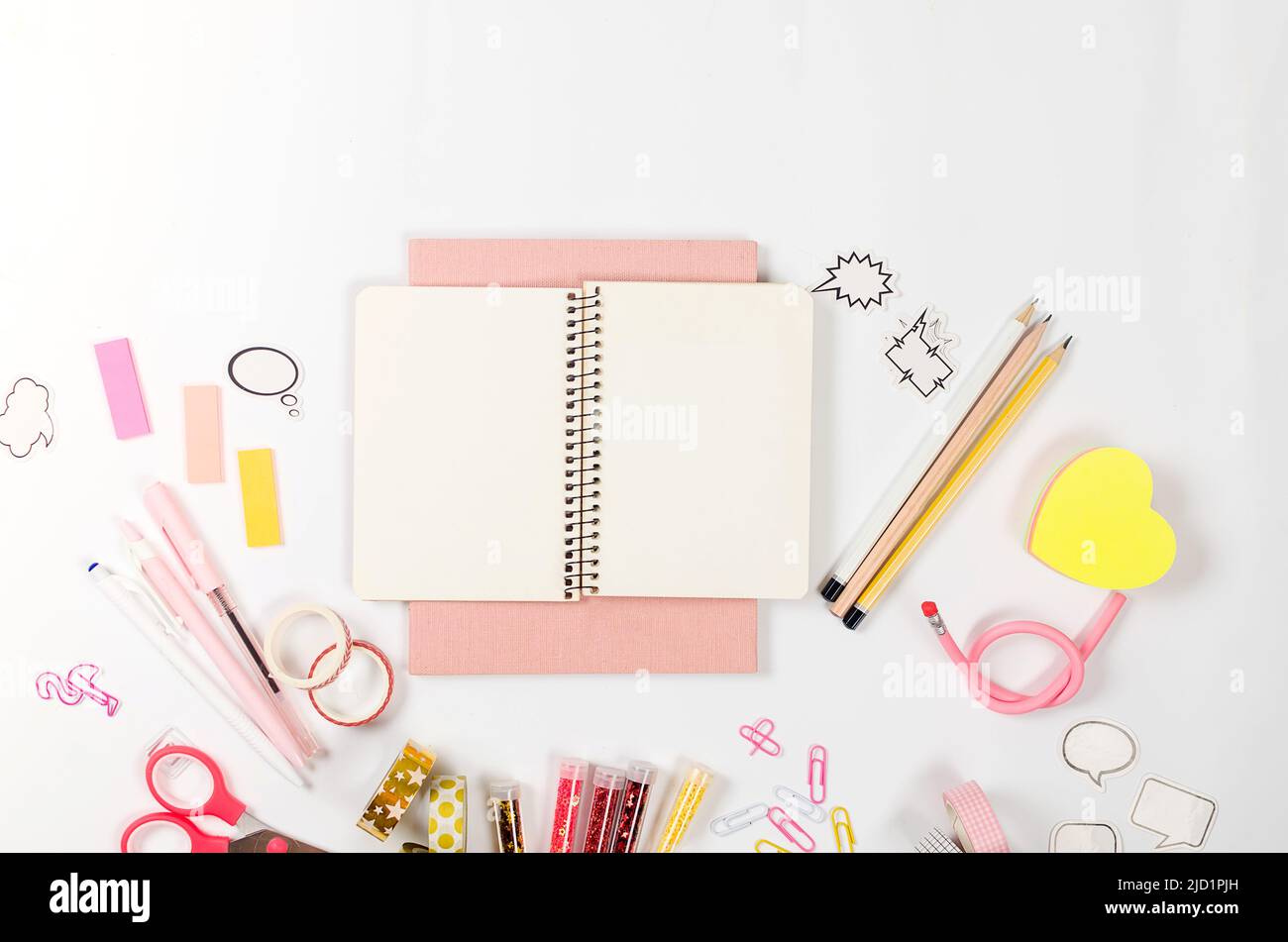 Girly pink desktop and stationery with blank notebook. Frame of ...
