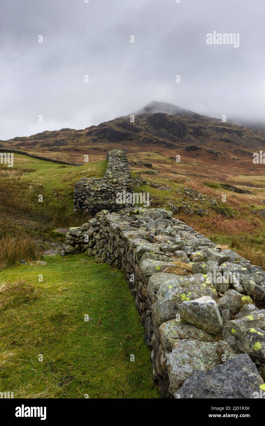 The outer wall of Hardknott Roman Fort below Border End summit in the ...