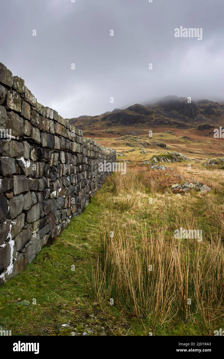 The outer wall of Hardknott Roman Fort below Border End summit in the ...