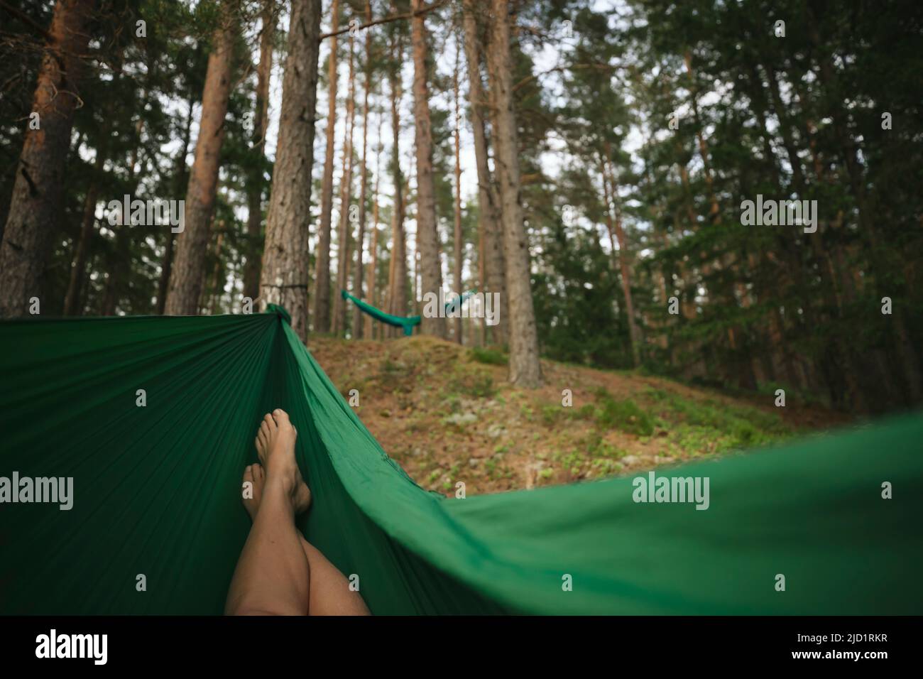 Low section of woman relaxing on hammock Stock Photo - Alamy