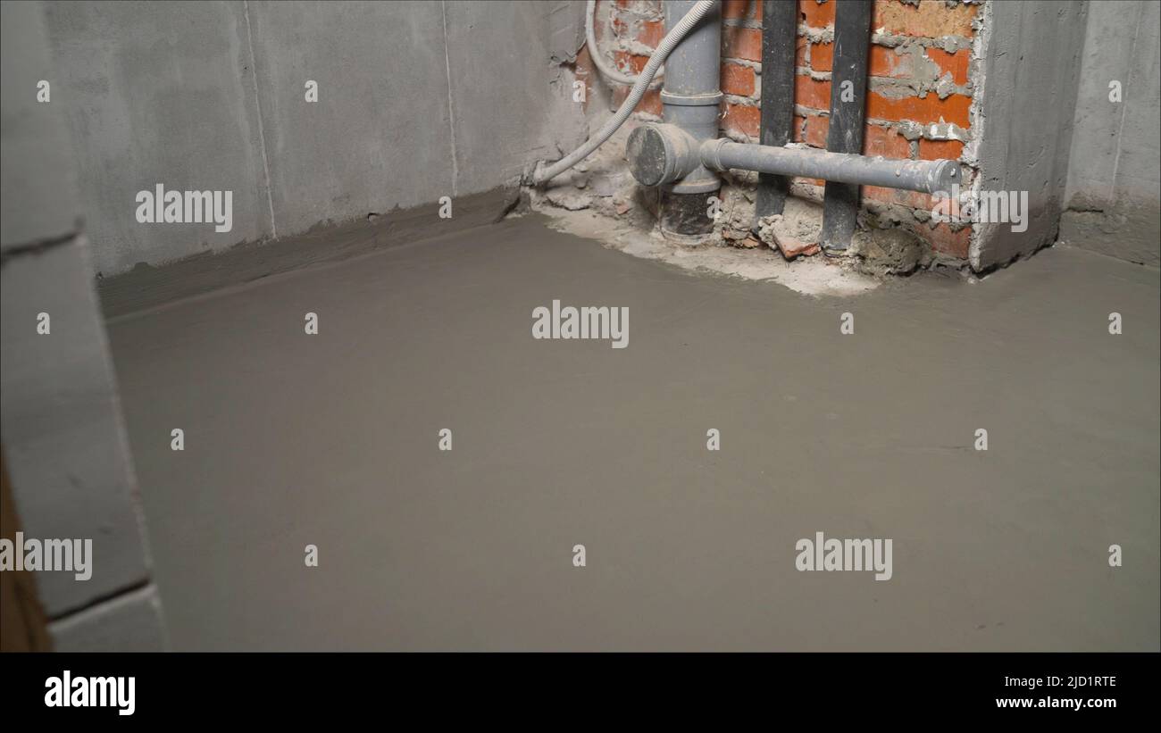 Primer for concrete floor before finishing. Repair in the house. Copy ...