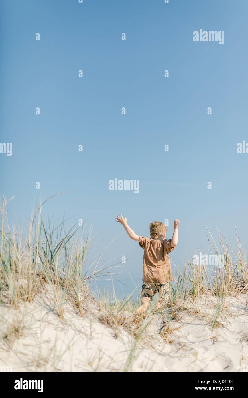 Boy running on sand dune hi-res stock photography and images - Alamy
