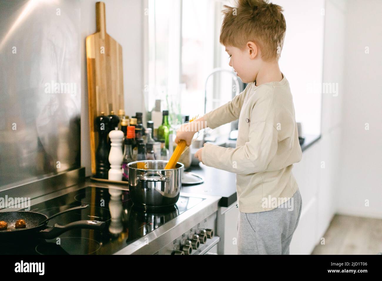 Boy preparing food in kitchen Stock Photo - Alamy