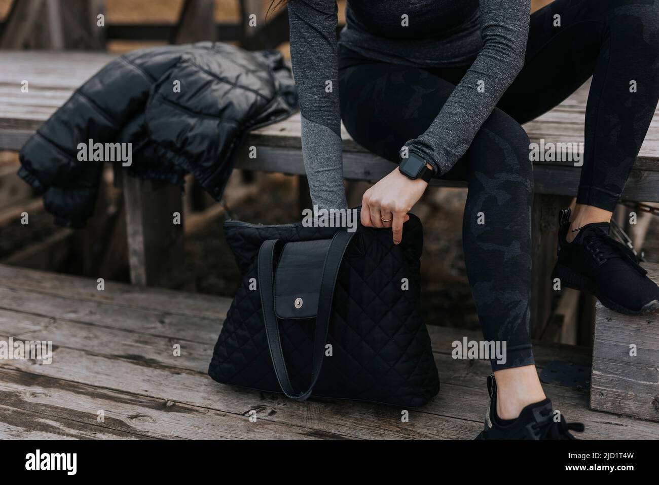 Woman's hands holding bag Stock Photo - Alamy