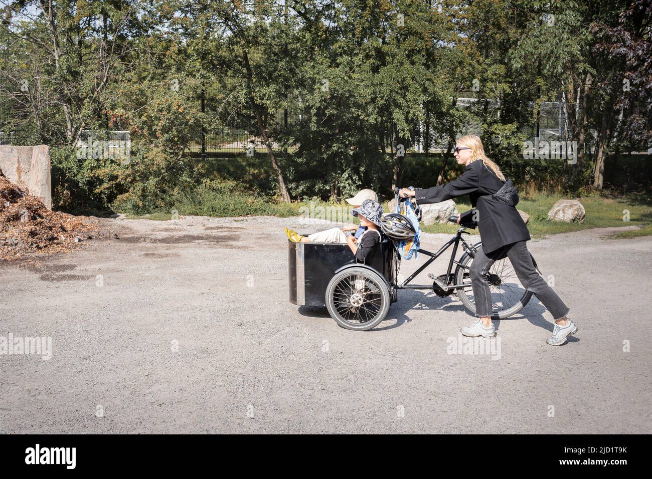 Boy pushing bicycle hi-res stock photography and images - Alamy
