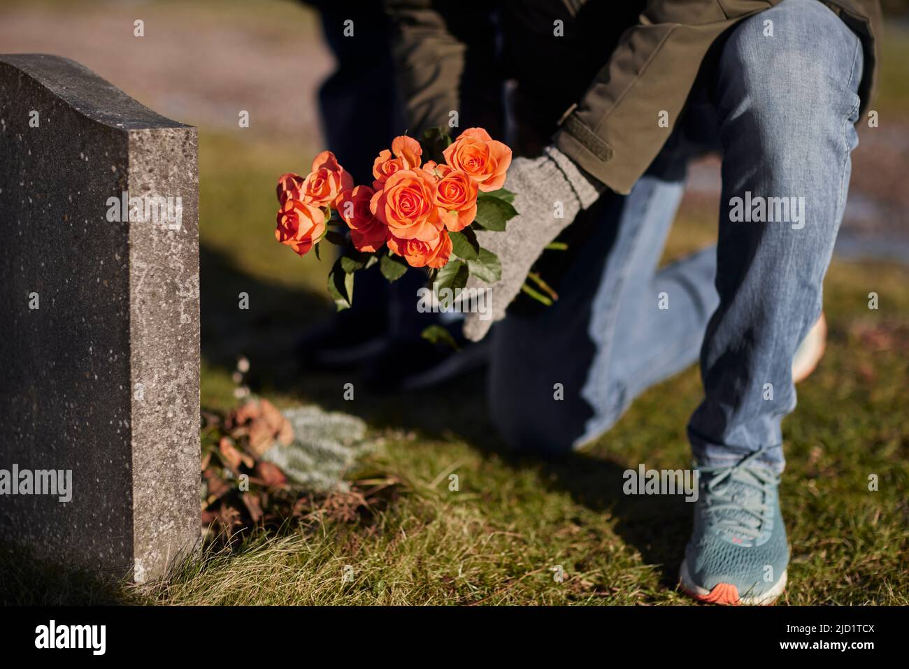 Man kneeling cemetery hi-res stock photography and images - Alamy