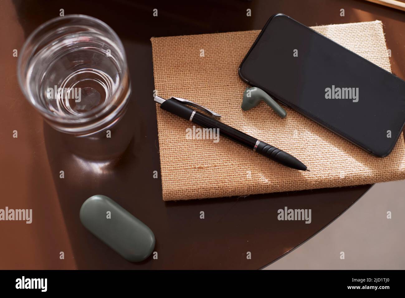 Smartphone and earbuds on notebook Stock Photo - Alamy