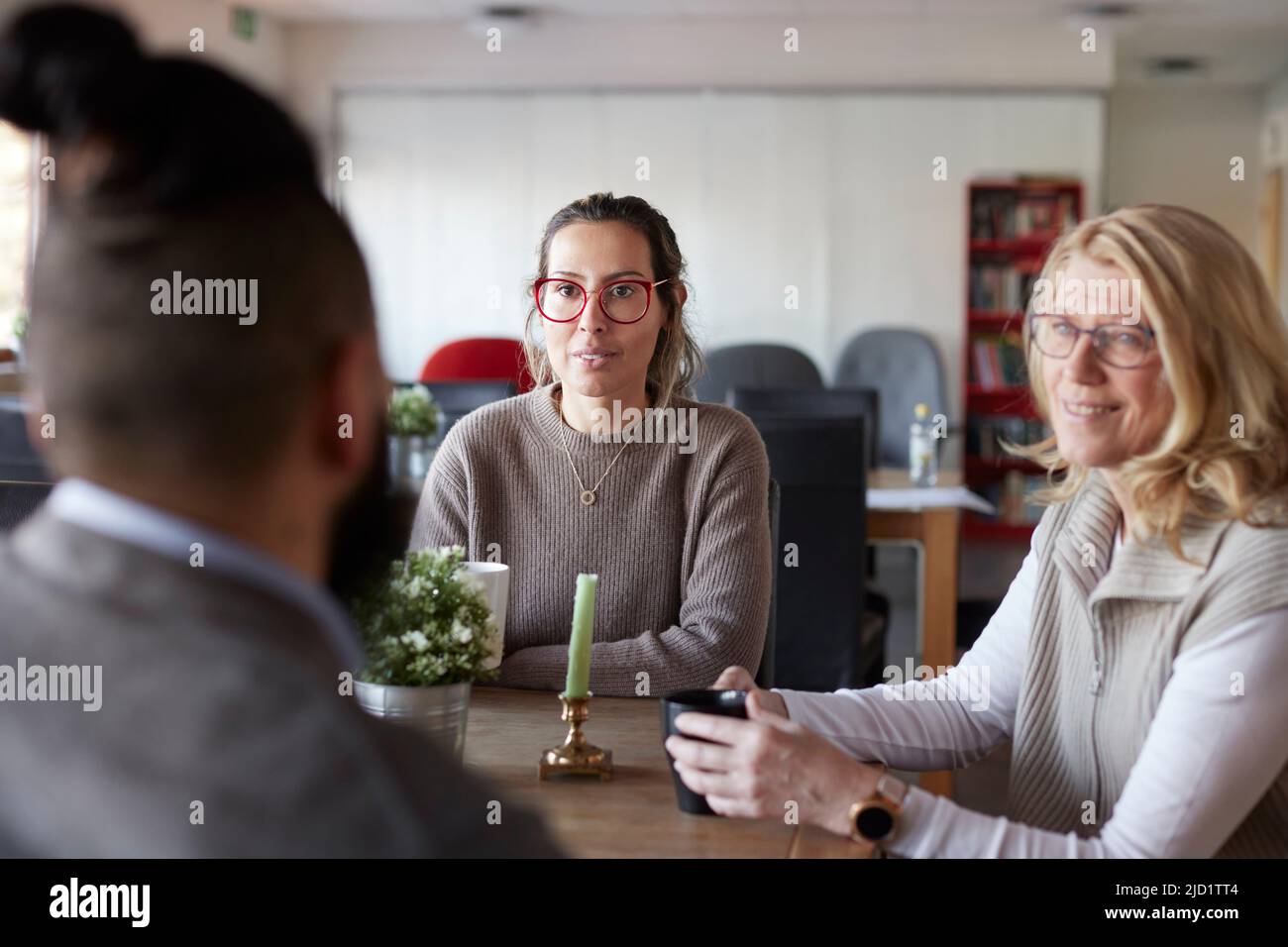 Co-workers talking during coffee break Stock Photo - Alamy