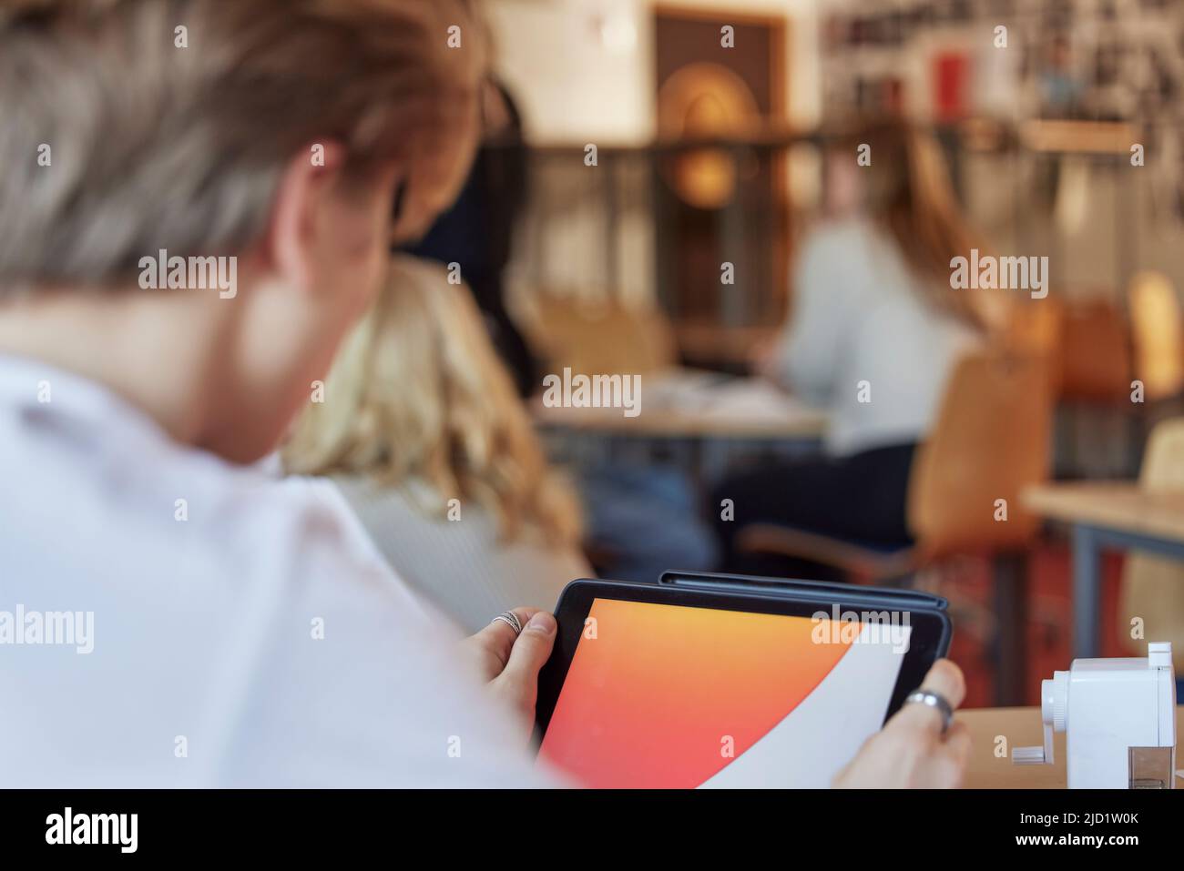 Student using tablet in class Stock Photo - Alamy