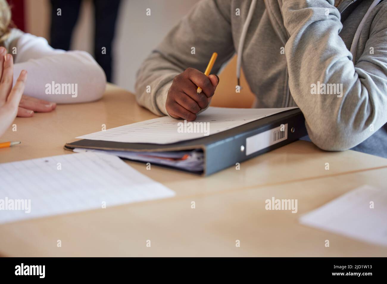Student taking notes in class Stock Photo - Alamy