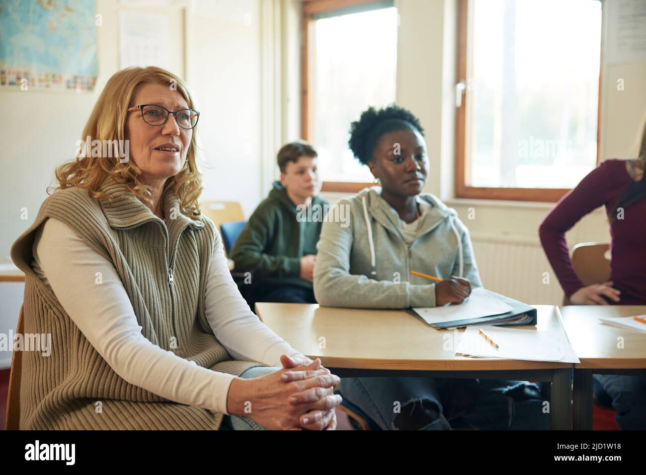 Group of students and teacher sitting in class Stock Photo - Alamy