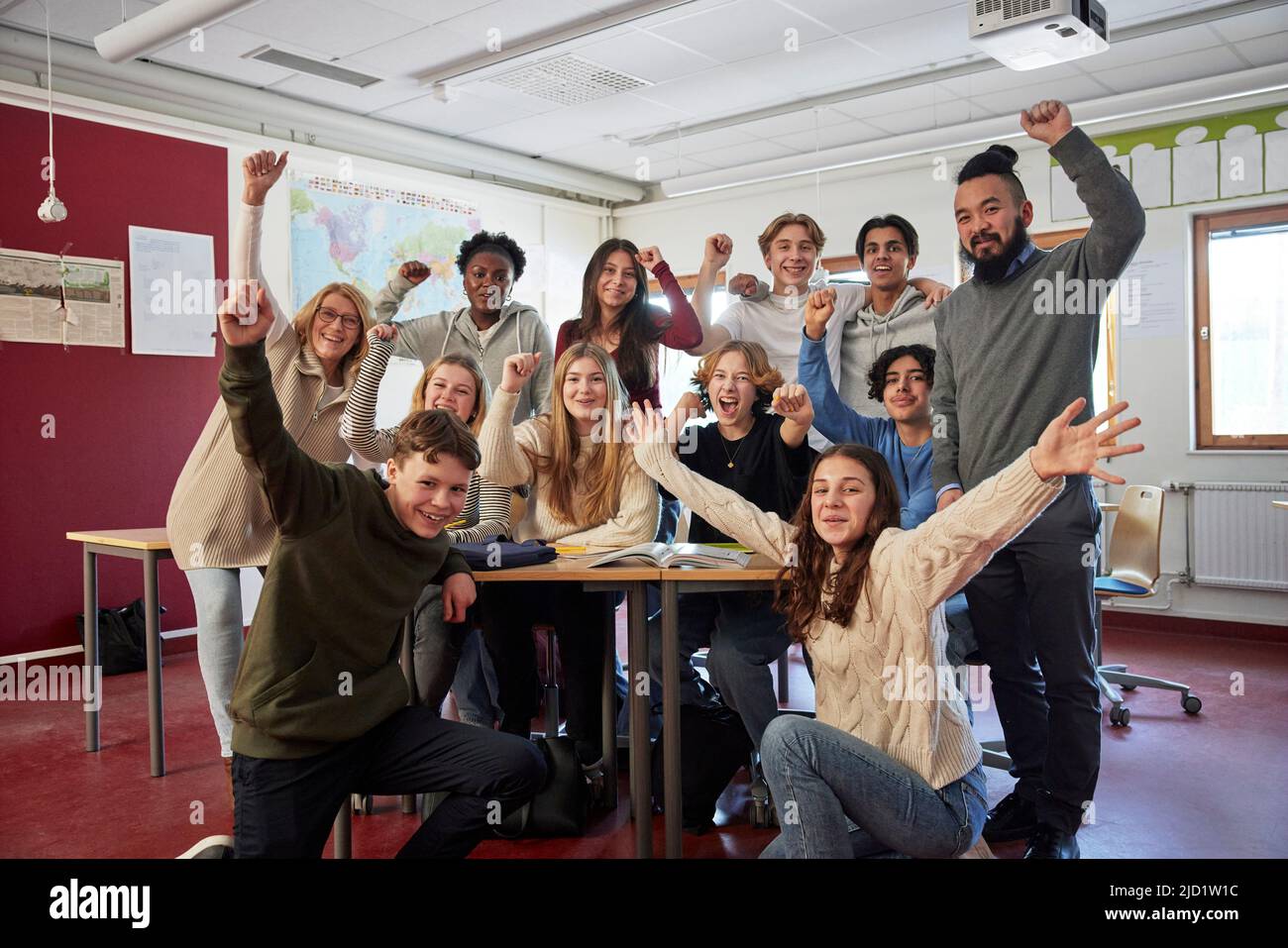 Portrait of students and teachers cheering in class Stock Photo - Alamy