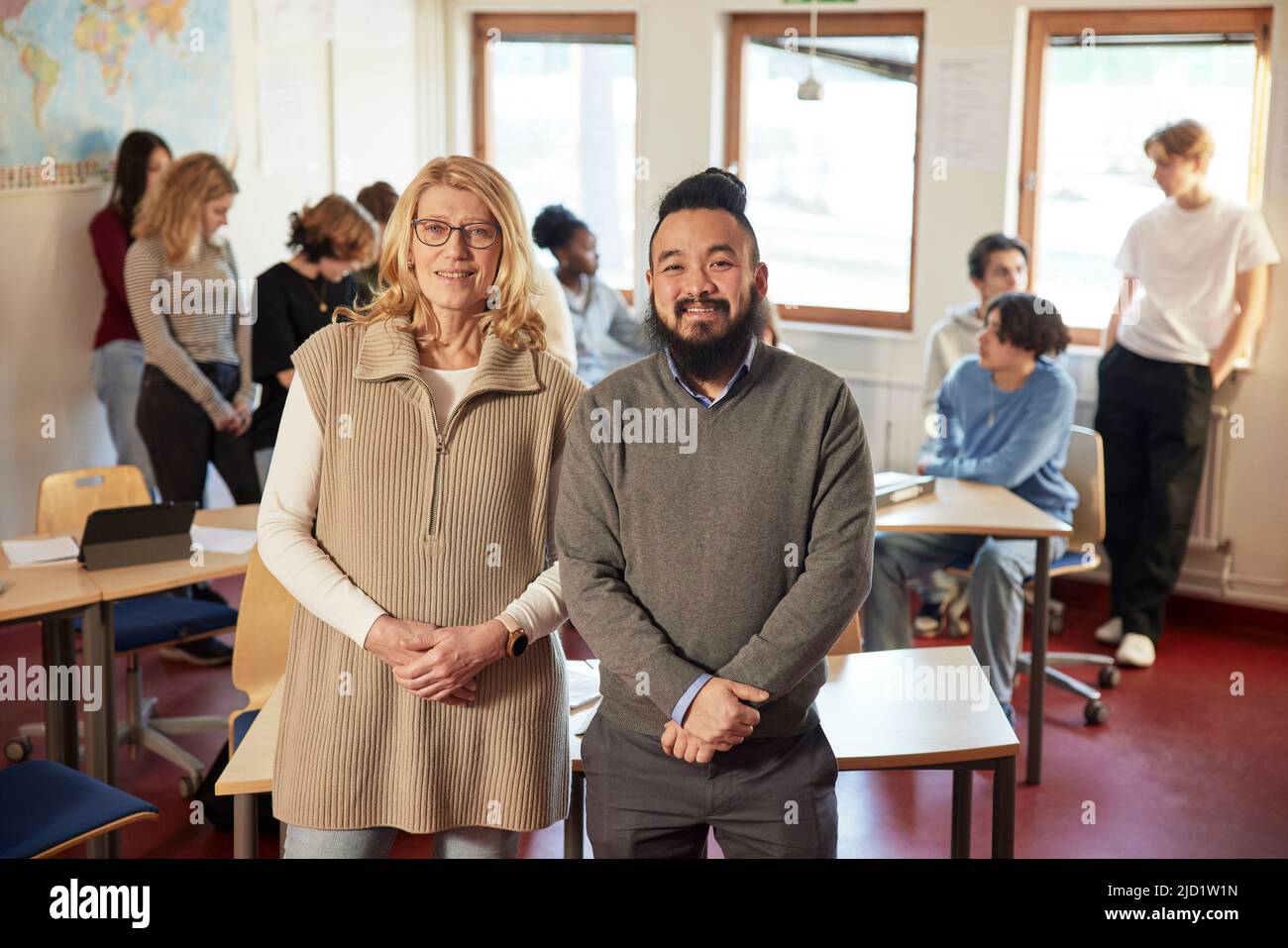 Portrait of teachers with students in background Stock Photo - Alamy