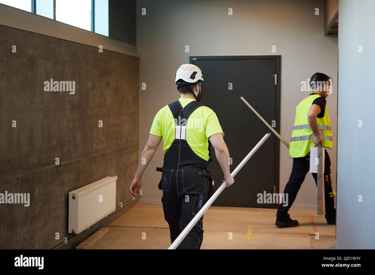 Three construction workers walking hi-res stock photography and images ...