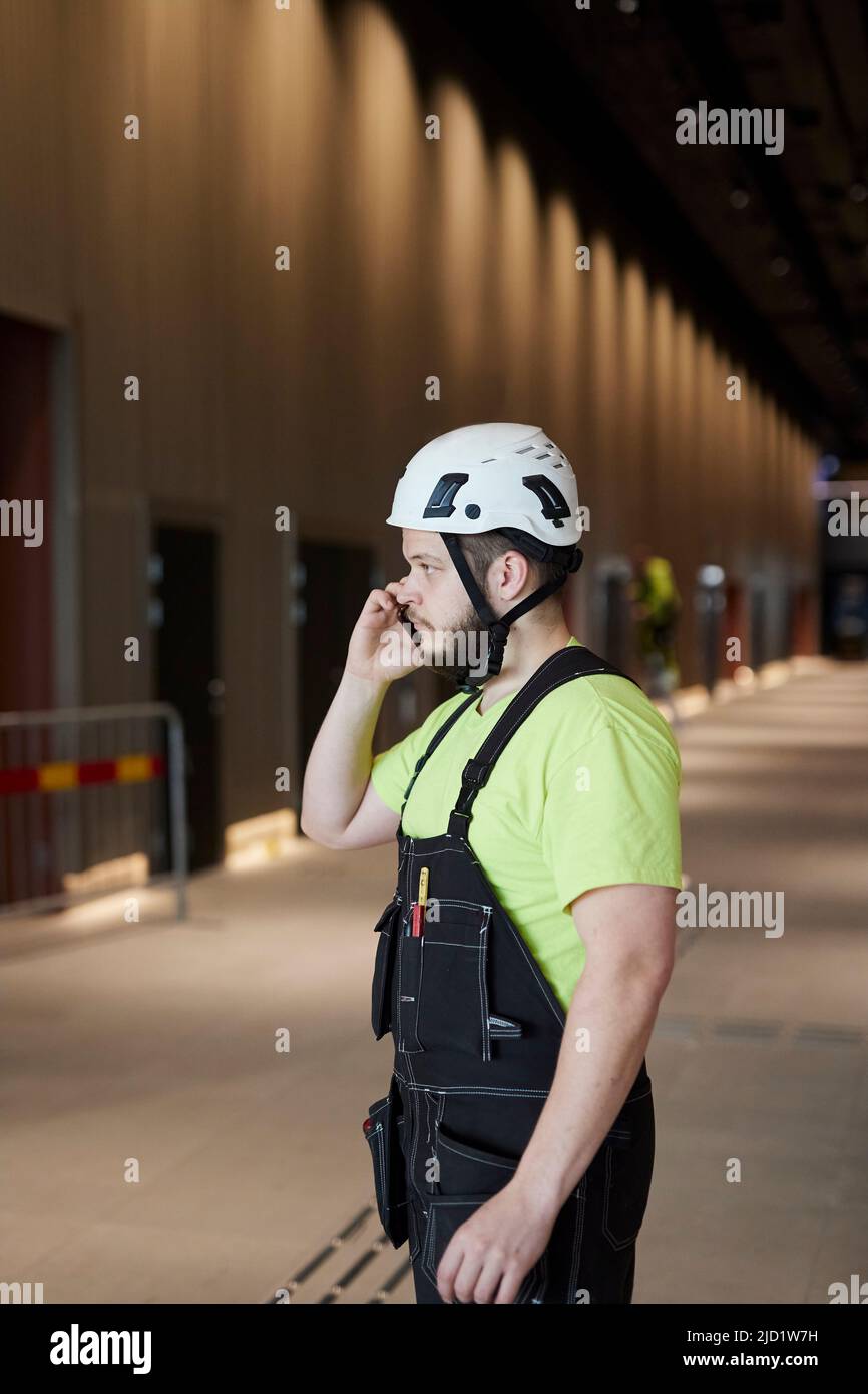 Construction worker using cell phone hi-res stock photography and ...