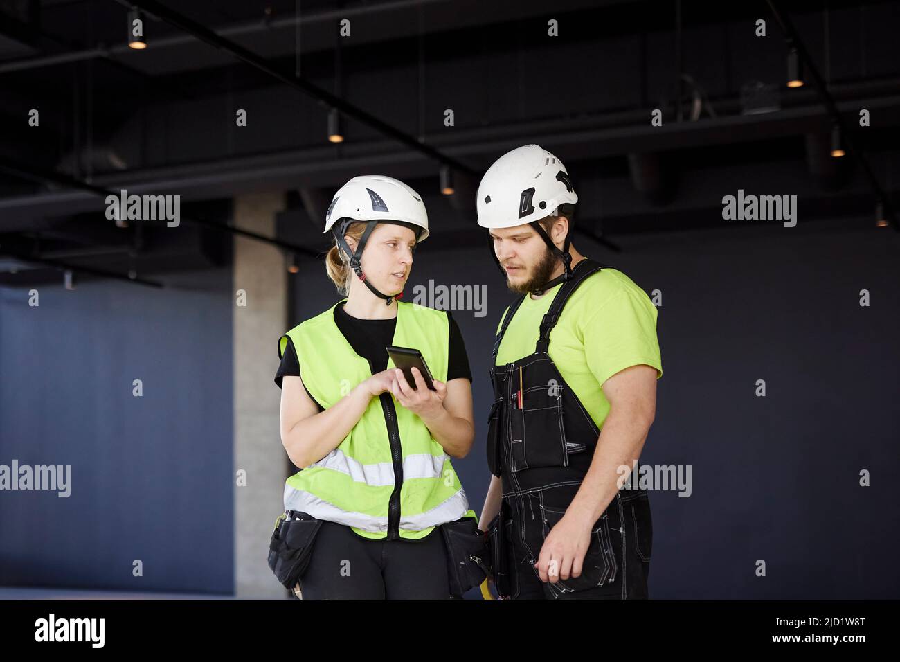 Workers talking together Stock Photo - Alamy