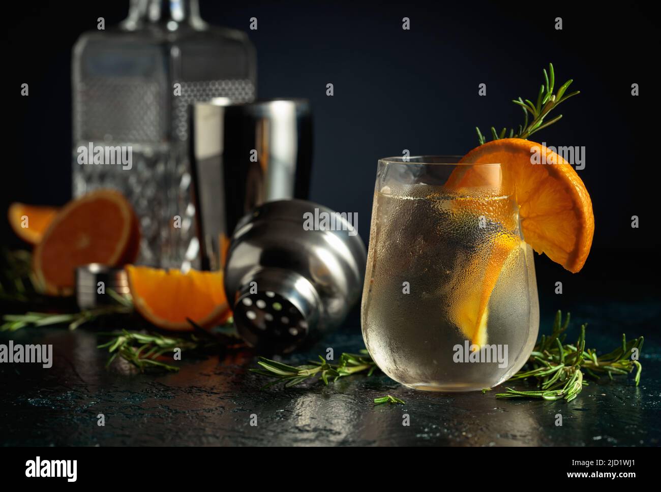 Cocktail gin tonic with ice, orange, and rosemary. Refreshing drink ...