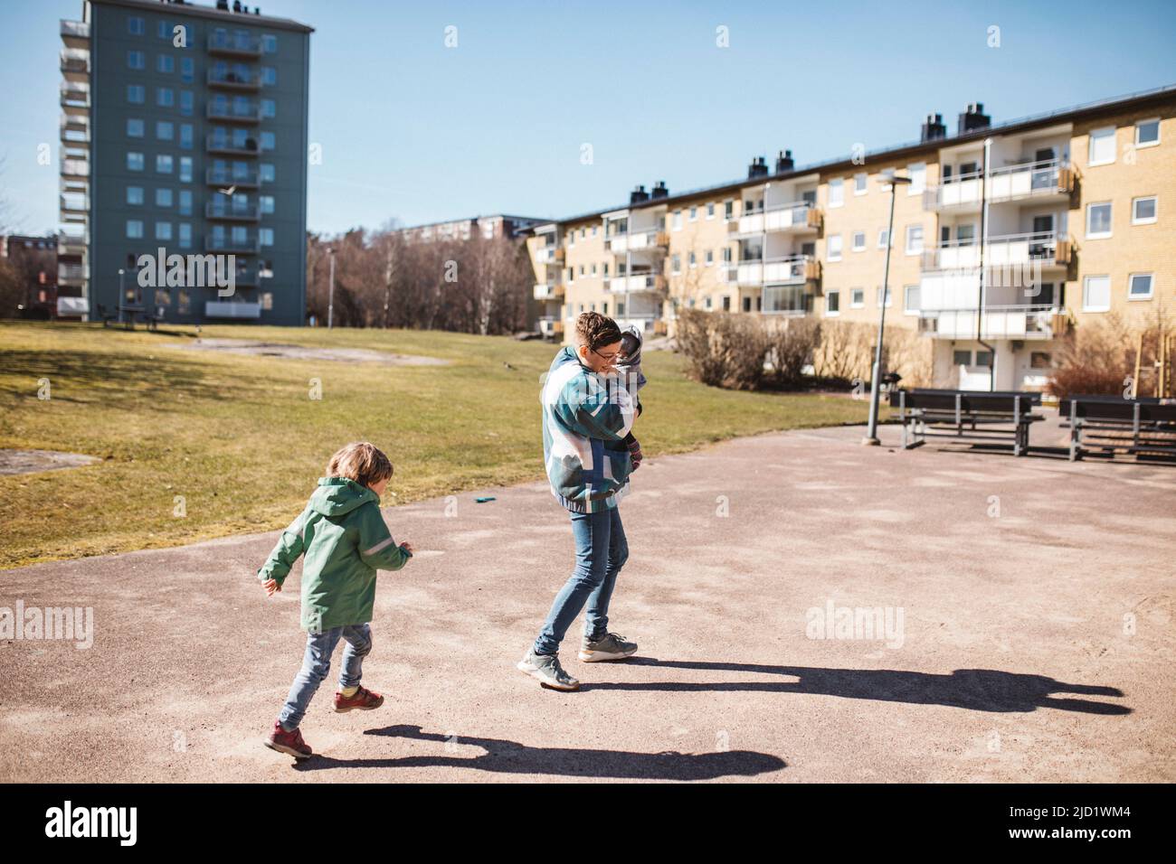 Mother walking with children Stock Photo - Alamy