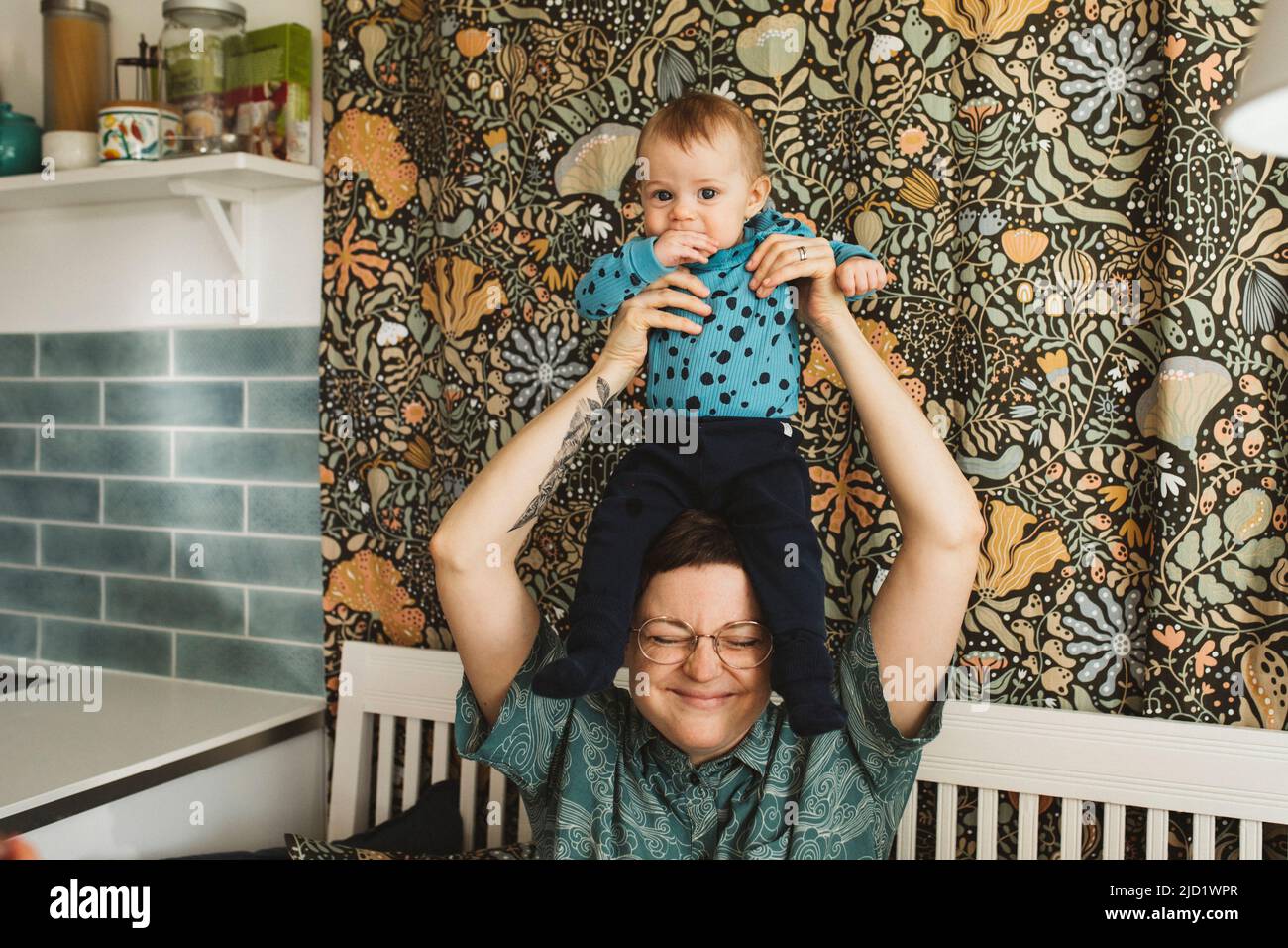 Mother and baby sitting together Stock Photo - Alamy