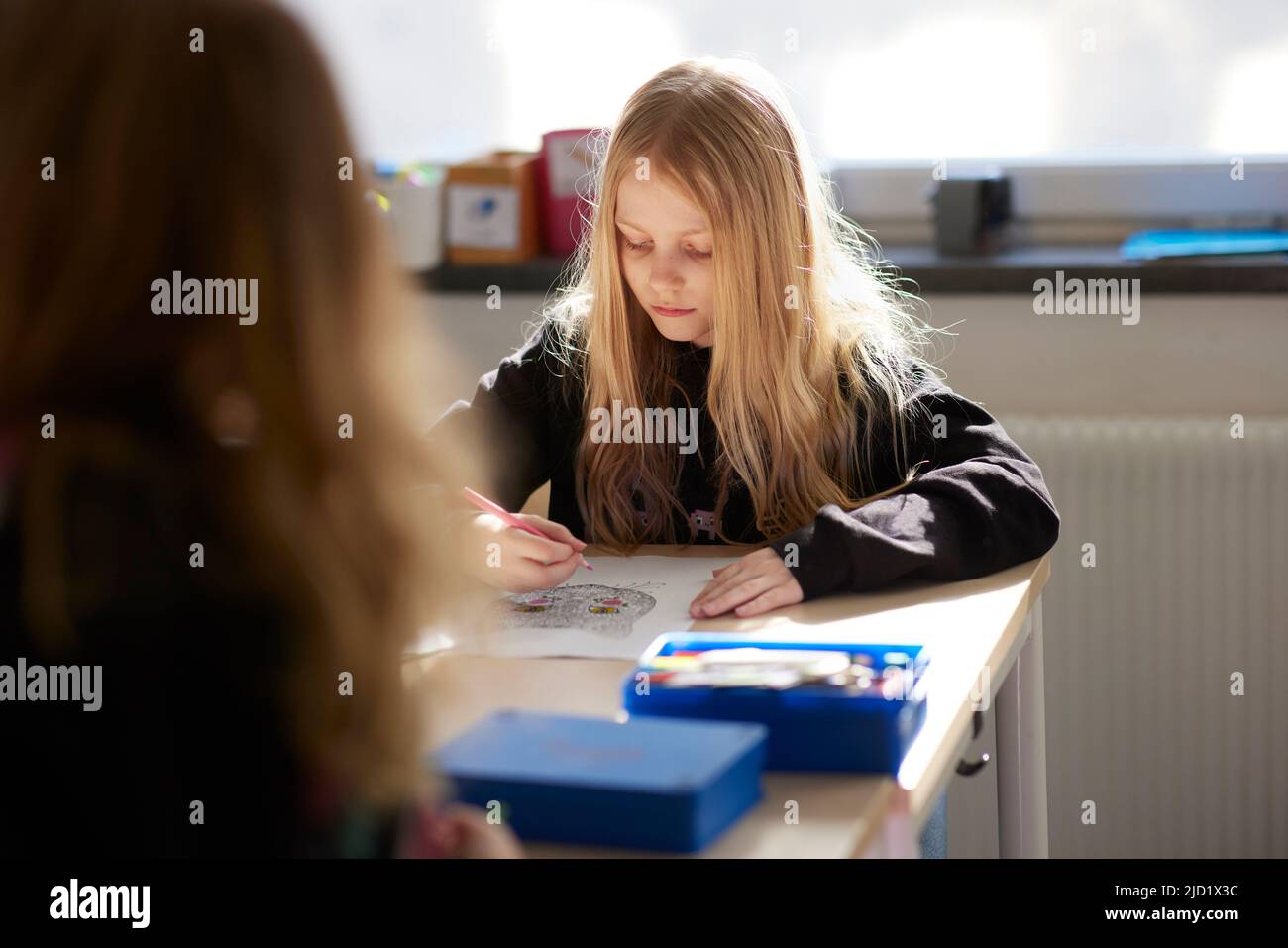 Girl sitting in classroom Stock Photo - Alamy