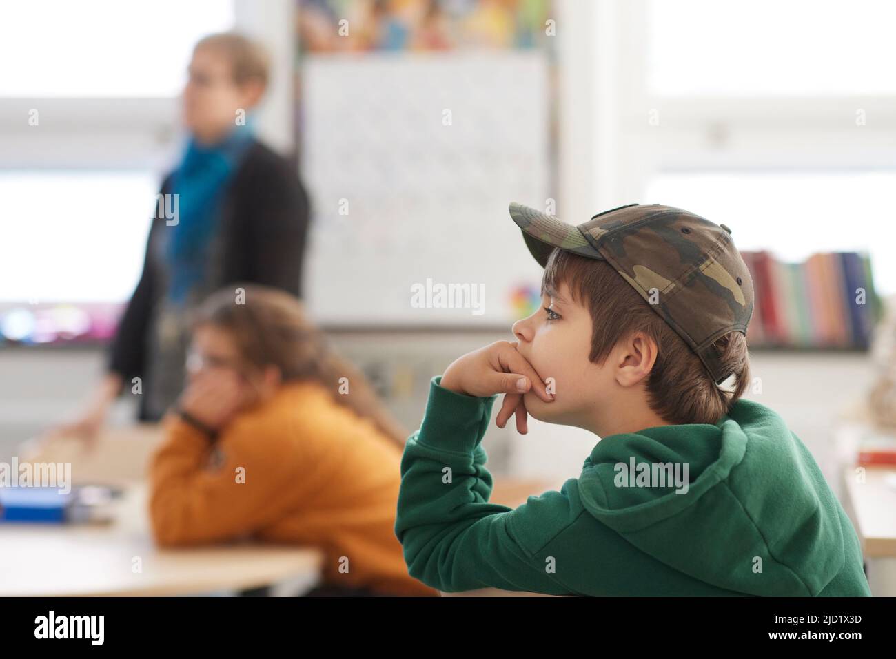 Boy sitting in classroom Stock Photo - Alamy