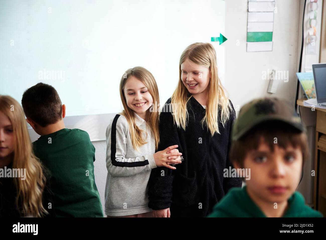 Smiling students in classroom Stock Photo - Alamy