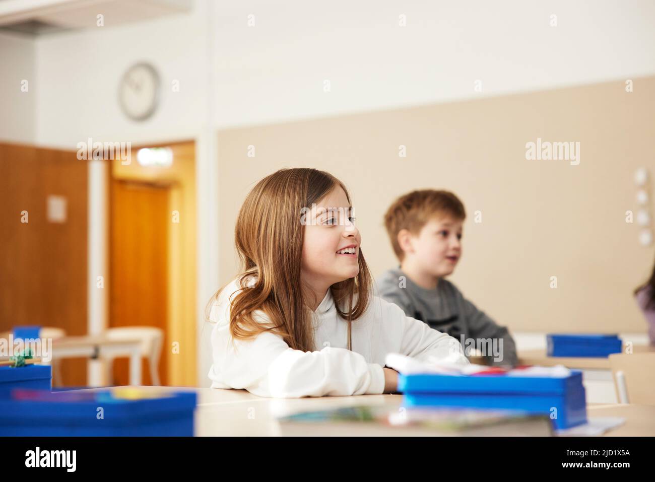 Girl sitting in classroom Stock Photo - Alamy