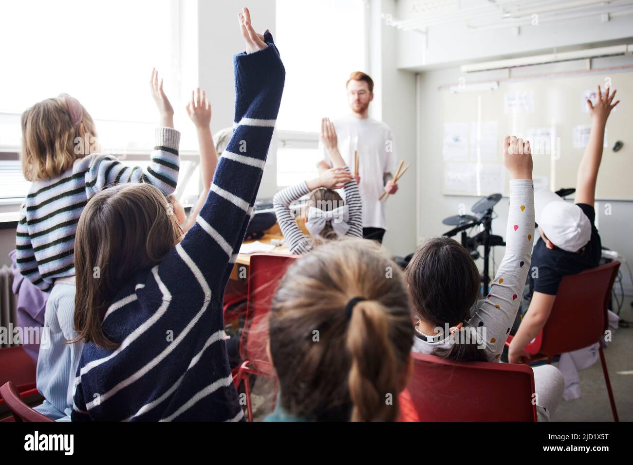 Children raising hands in class Stock Photo - Alamy