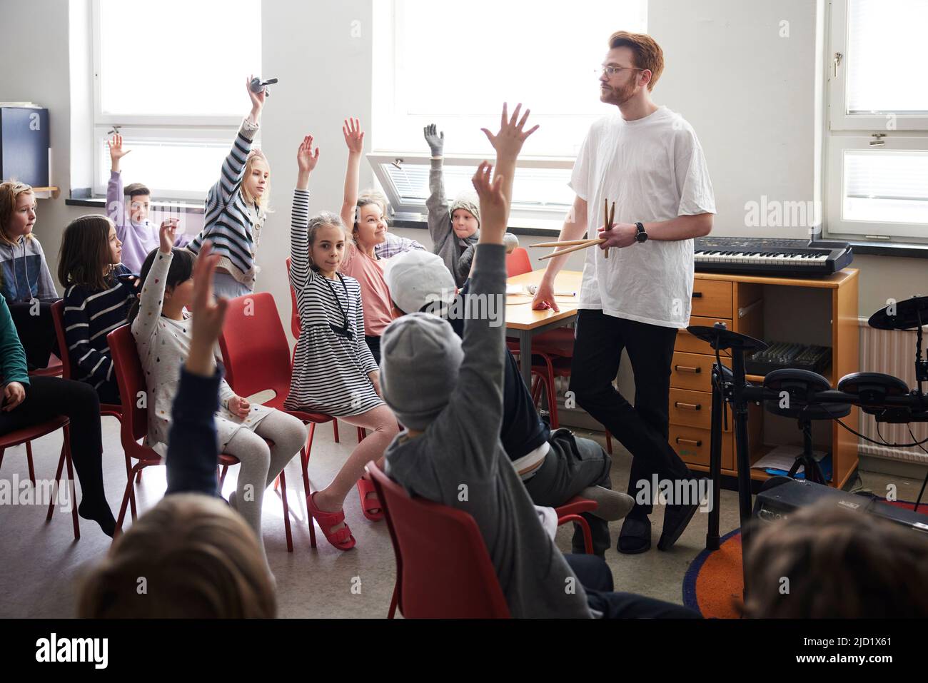 Children raising hands in class Stock Photo - Alamy