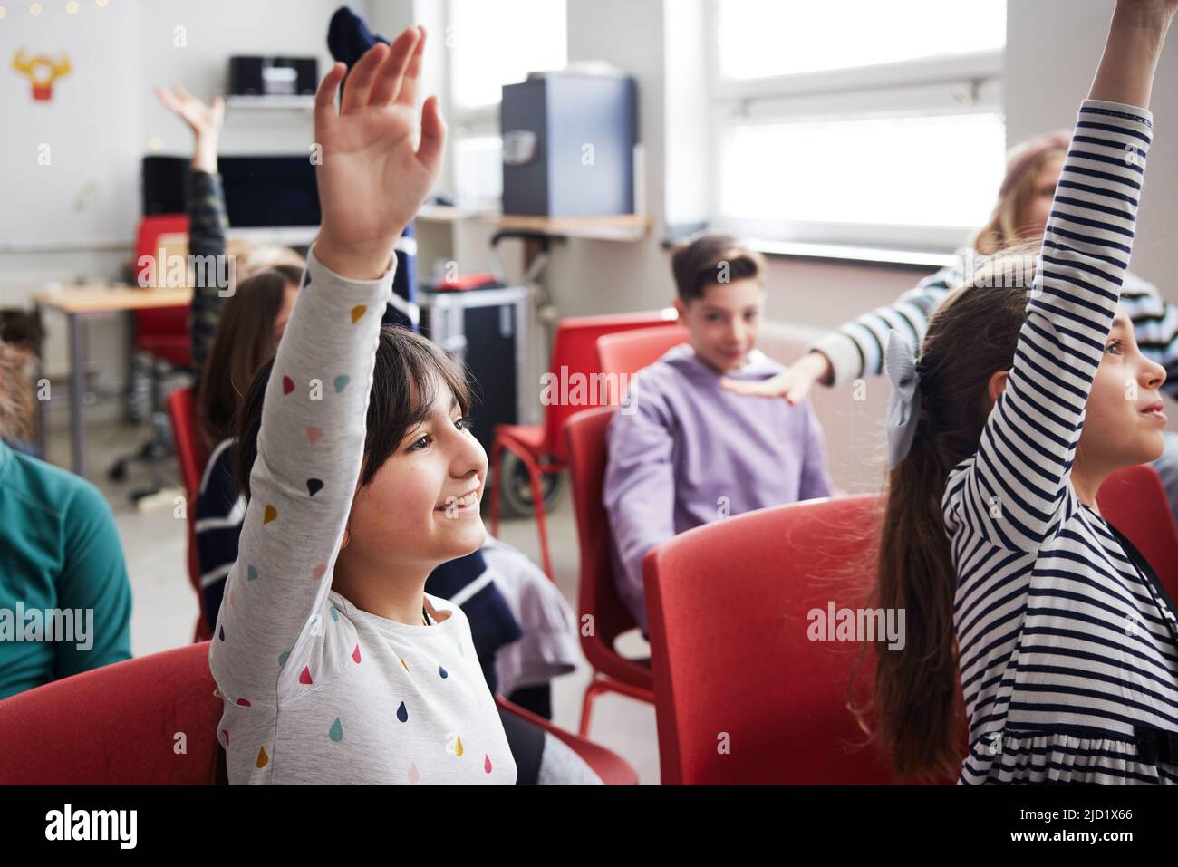 Children raising hands in class Stock Photo - Alamy