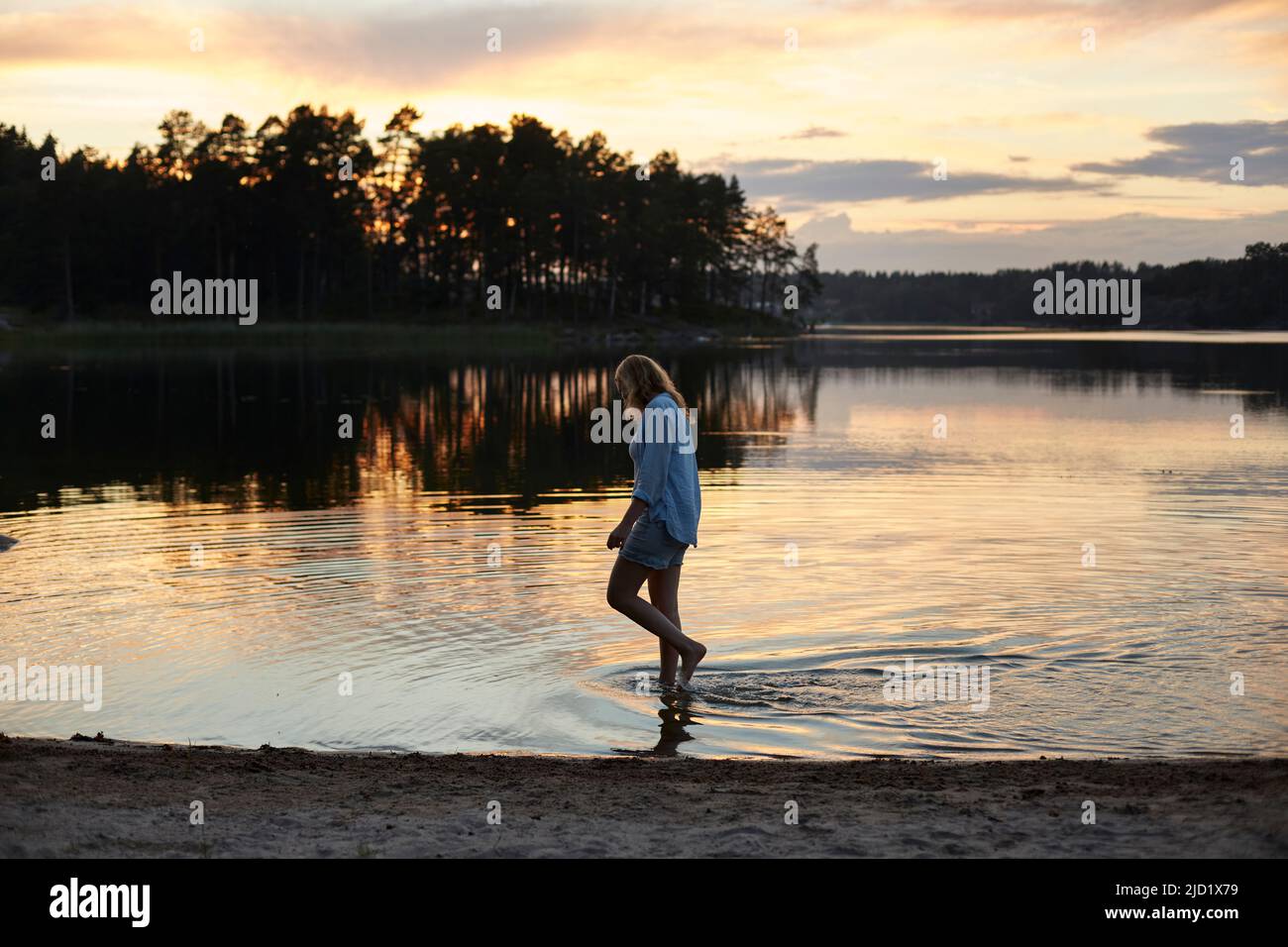 Woman walking at lake Stock Photo - Alamy
